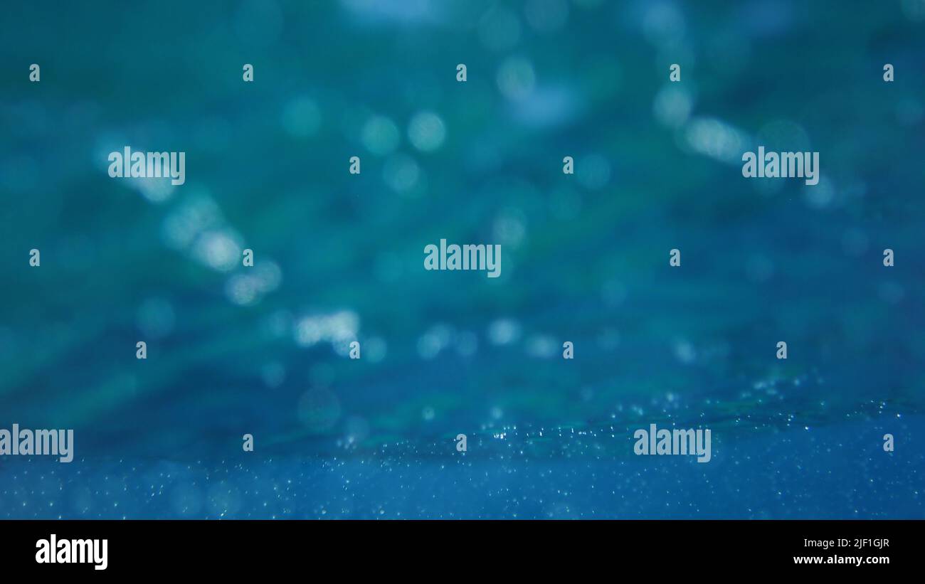 A sprakly blue ocean water background with copy space for design for ...