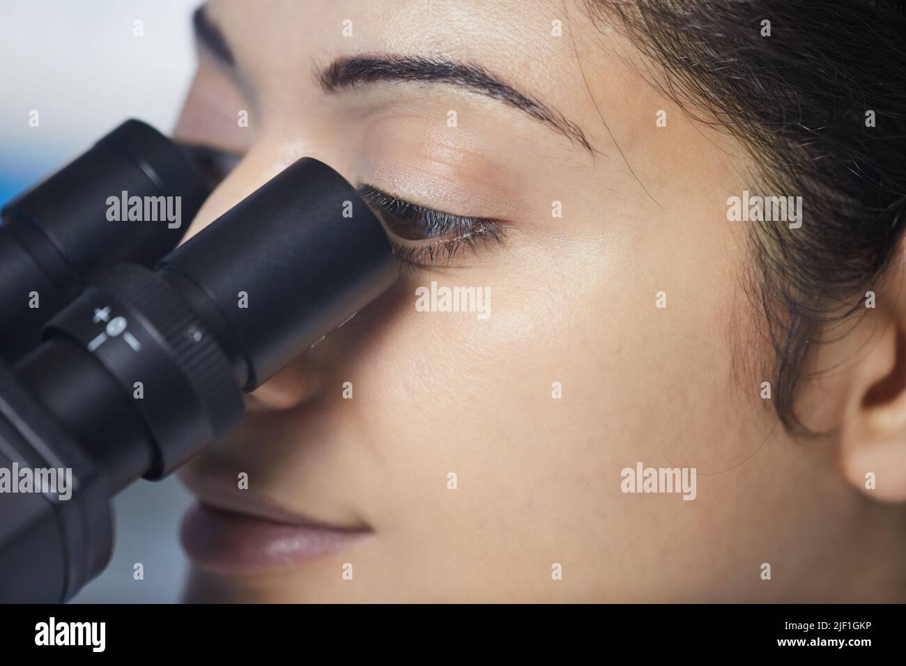 Close-up of serious young Indian researcher concentrated on scientific ...