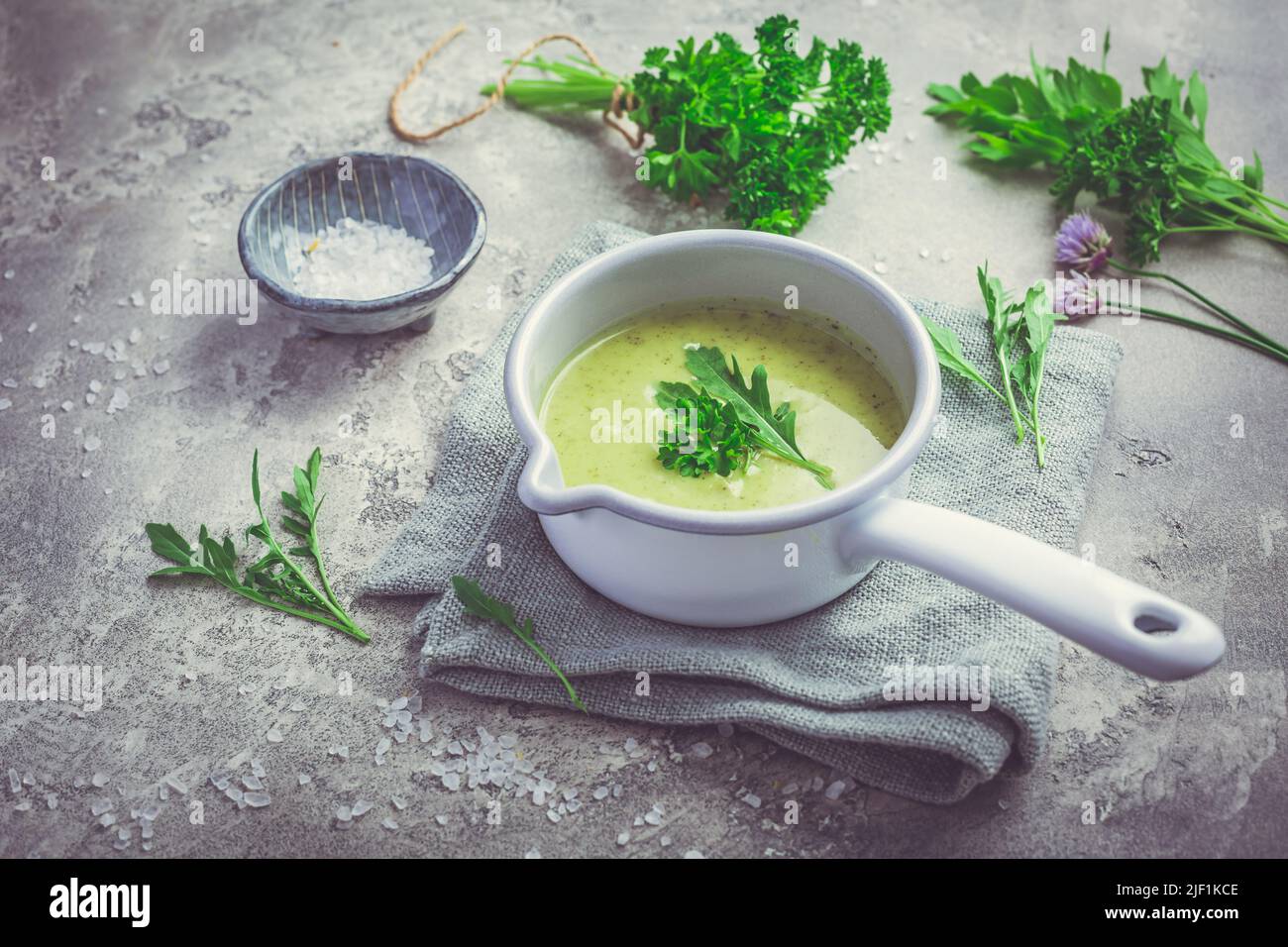 Healthy homemade green herb soup in pot made from local wild and garden ...