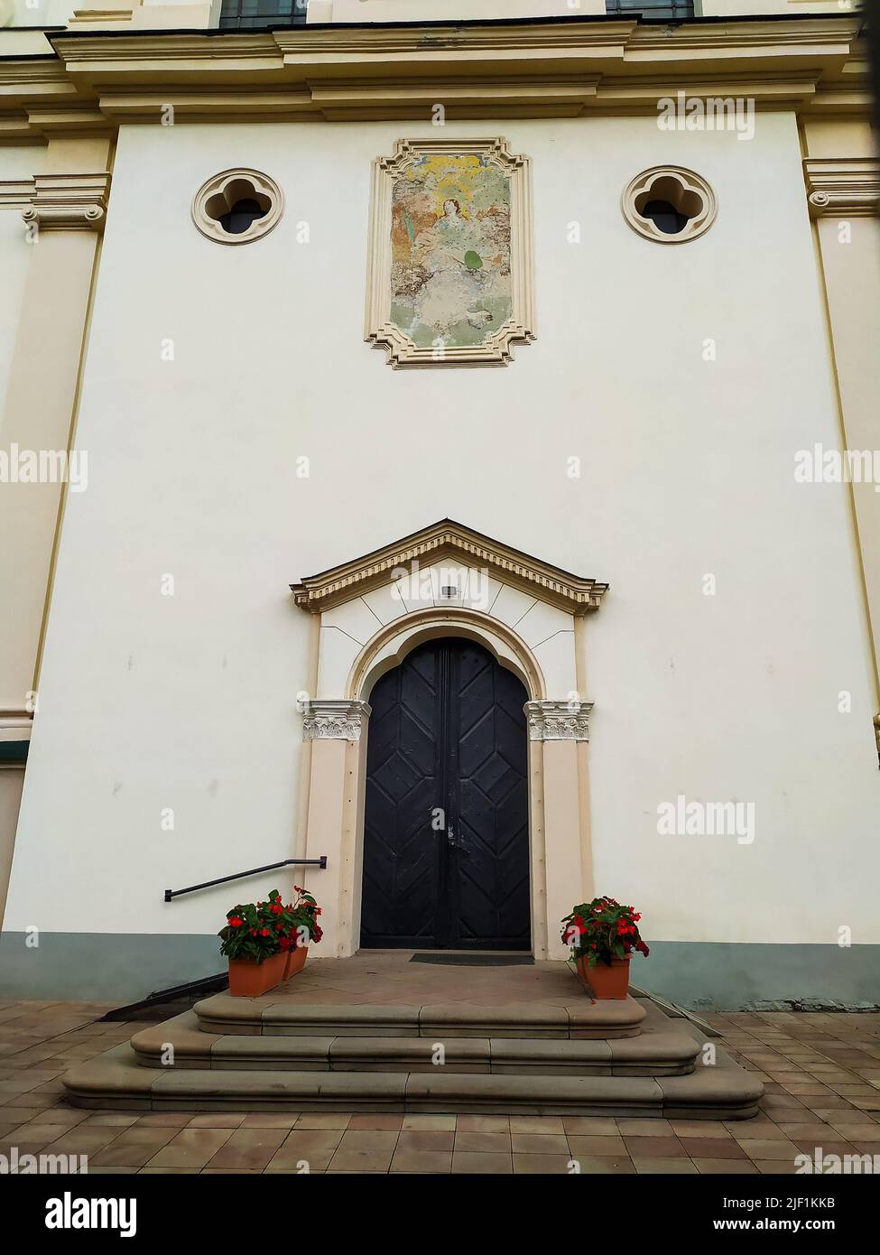 door with beautiful portal to the temple with two flower pots Stock ...