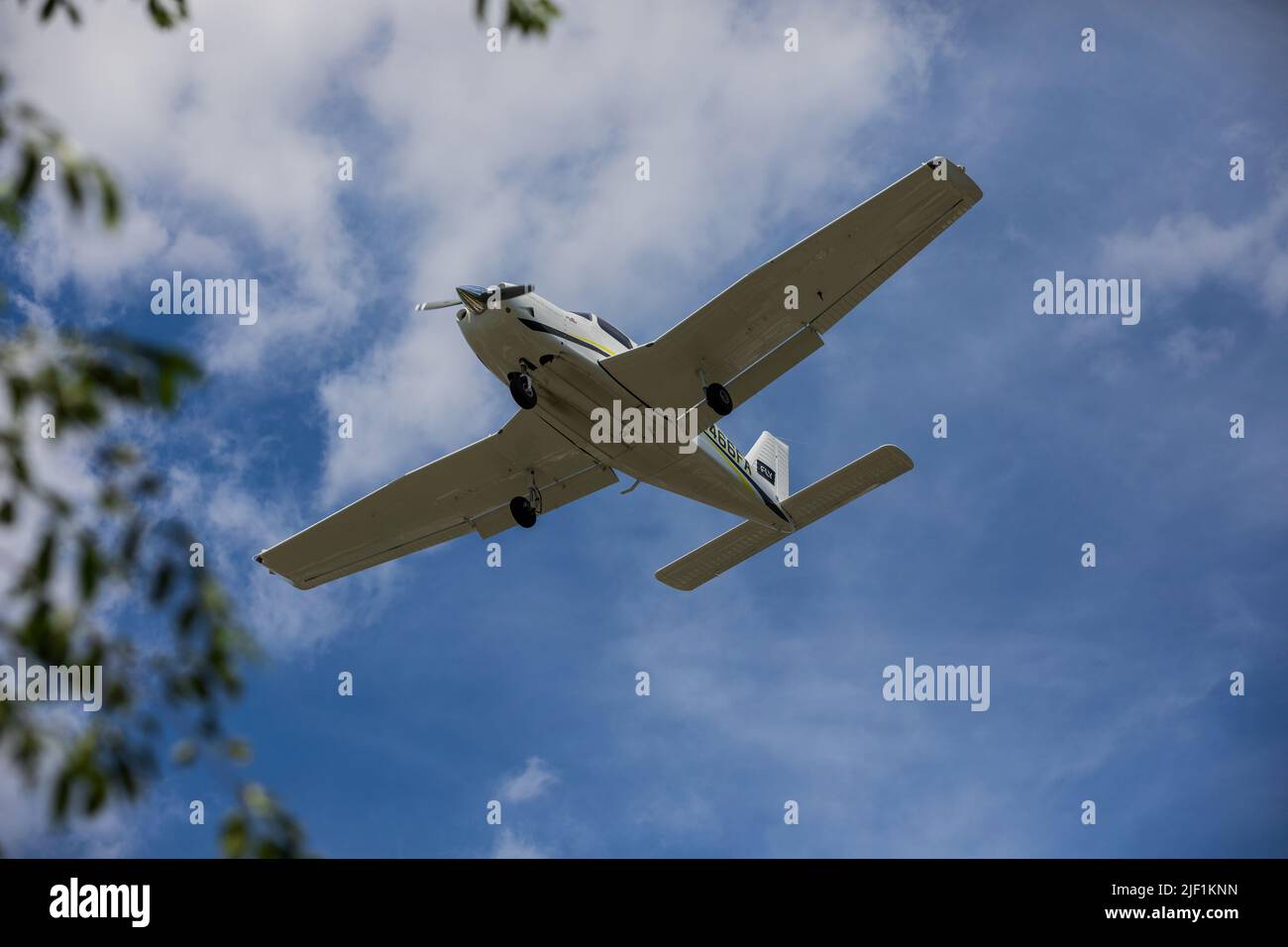 Small Plane Flies Overhead on Sunny Summer Day Stock Photo - Alamy