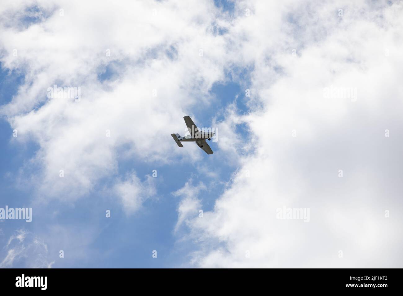 Small Plane Flies Overhead on Sunny Summer Day Stock Photo - Alamy