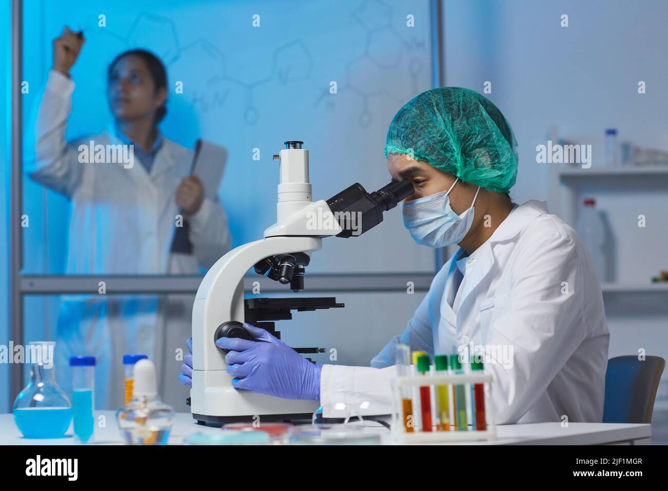 Scientist sitting desk working on hi-res stock photography and images ...