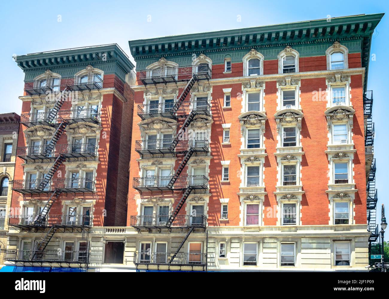 Red brick residential building on the corner of 5th Ave and W 120 st ...