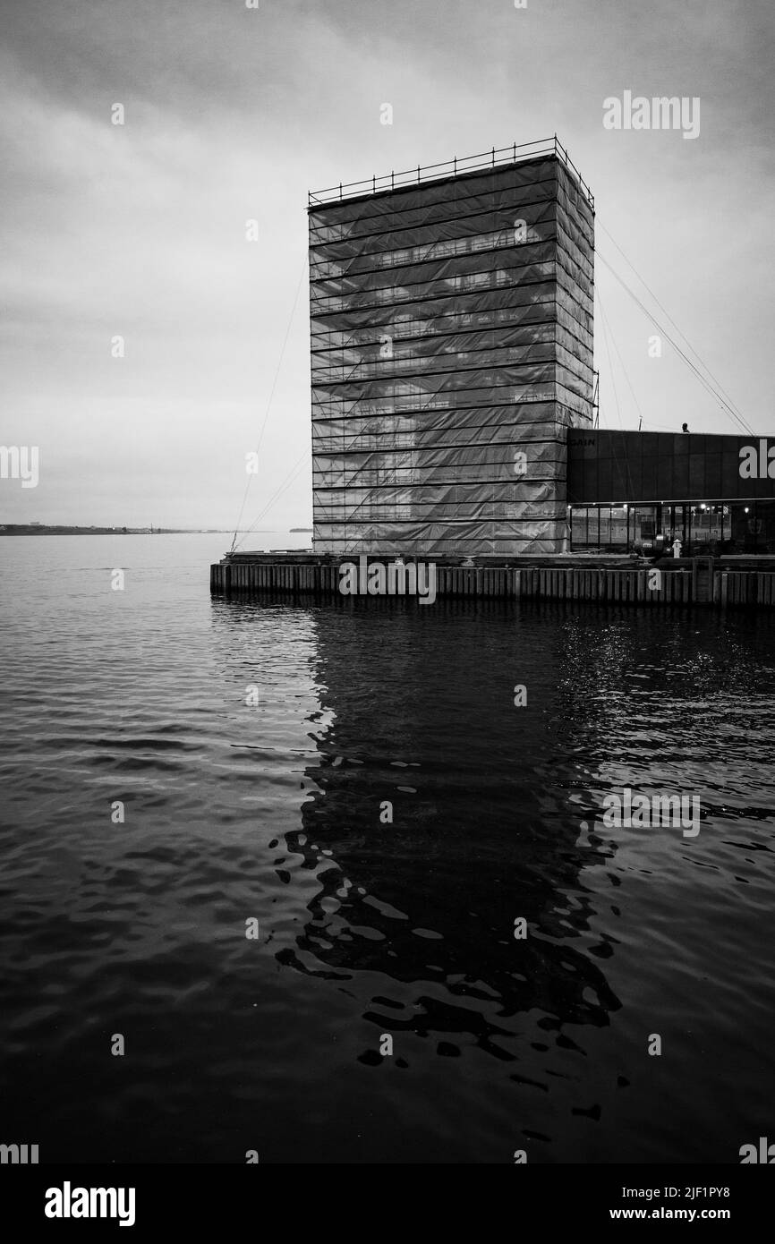 Temporary scaffolding skinned with tarpaulins surrounds the ...