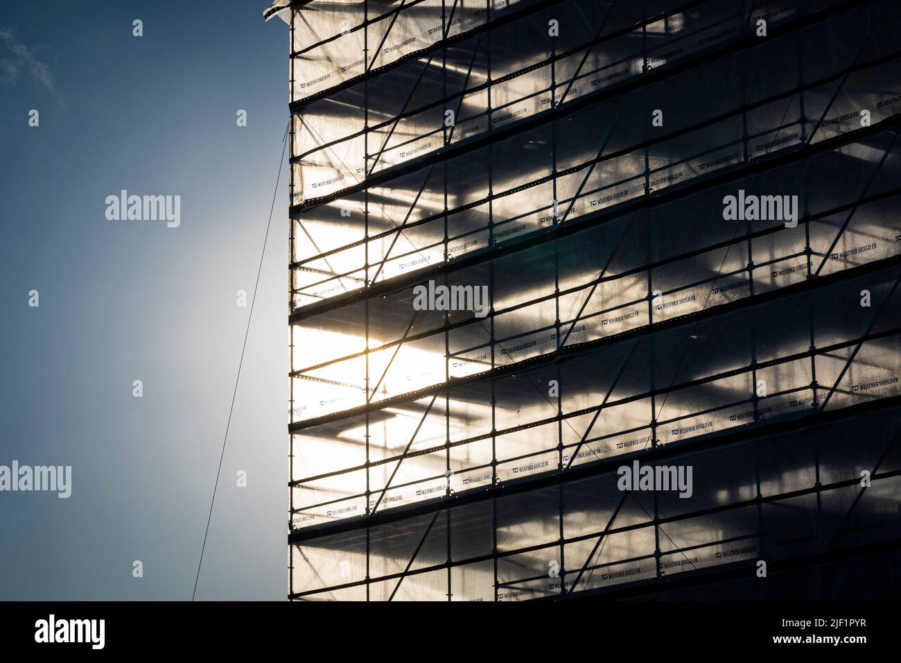 Temporary scaffolding skinned with tarpaulins surrounds the ...