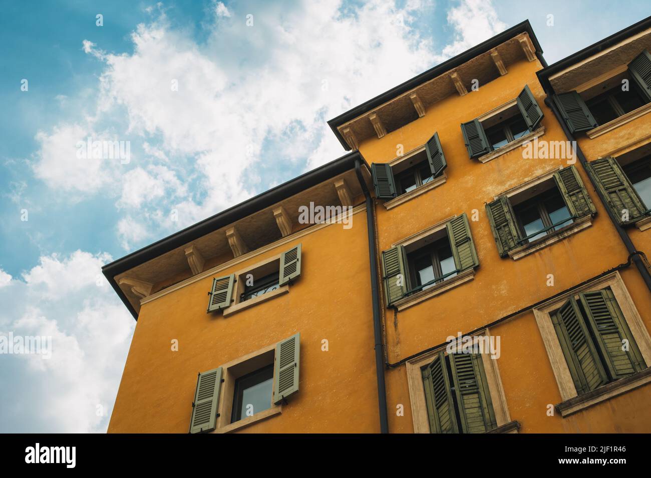 Beautiful old buildings on Verona street, Italy. Amazing blue sky ...