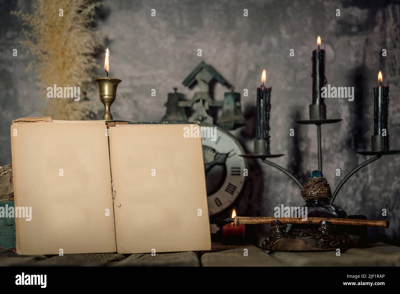 Antique parchment paper sheets roll tied with string lit by candlelight ...