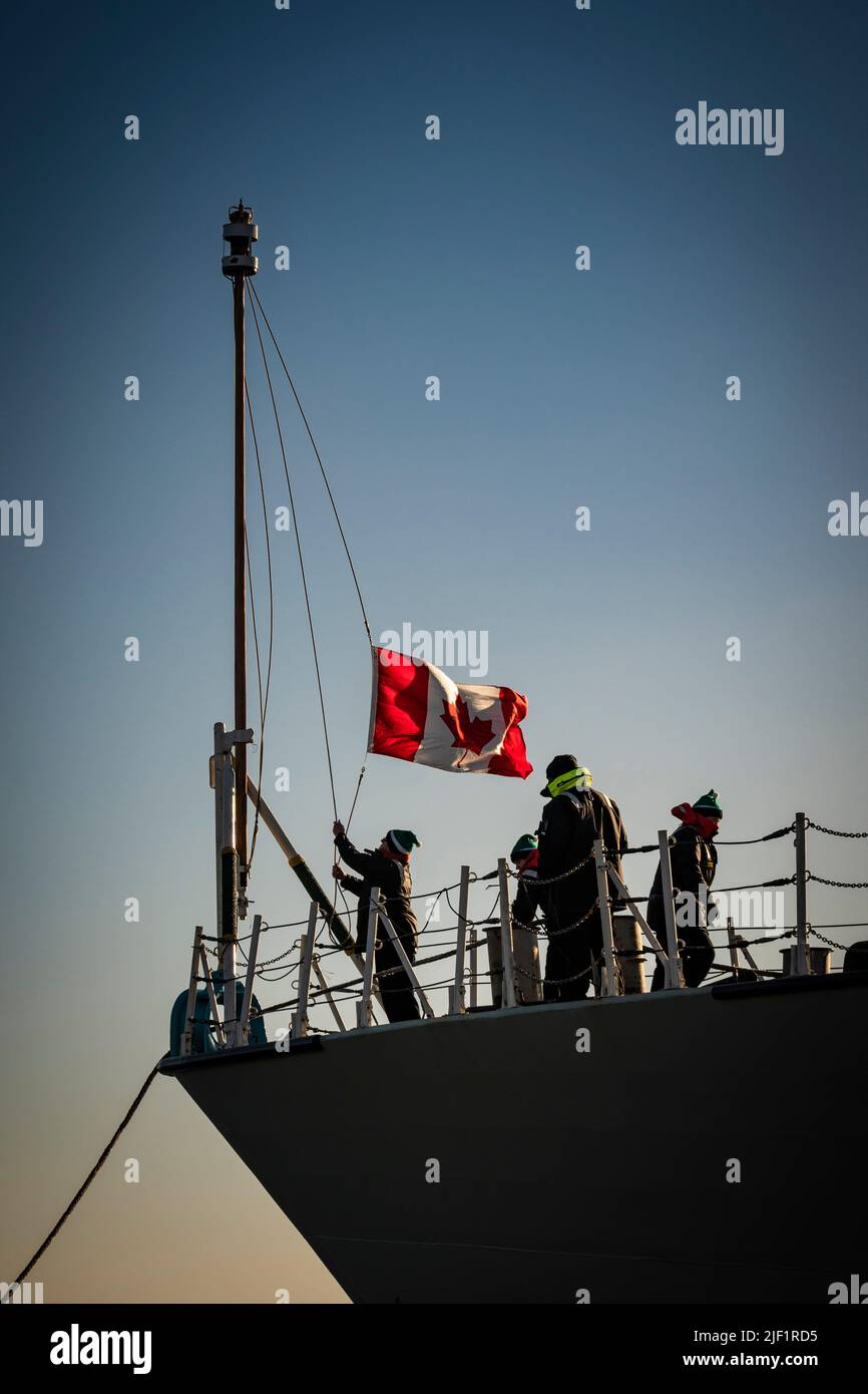 Crew lowers the Canadian Flag jack onboard HMCS Fredericton returns to ...