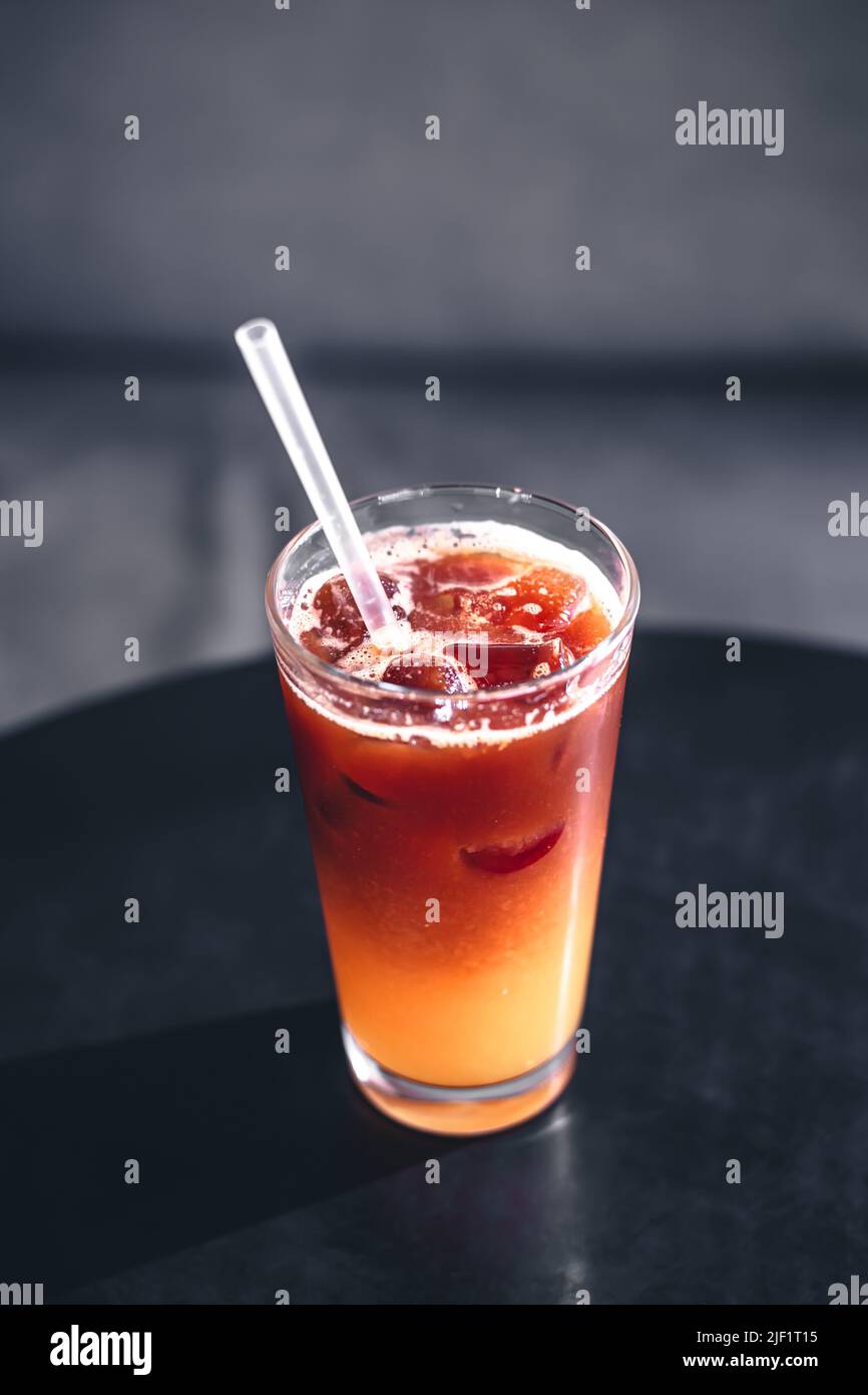 Cold summer coffee drink with ice and orange juice Stock Photo - Alamy