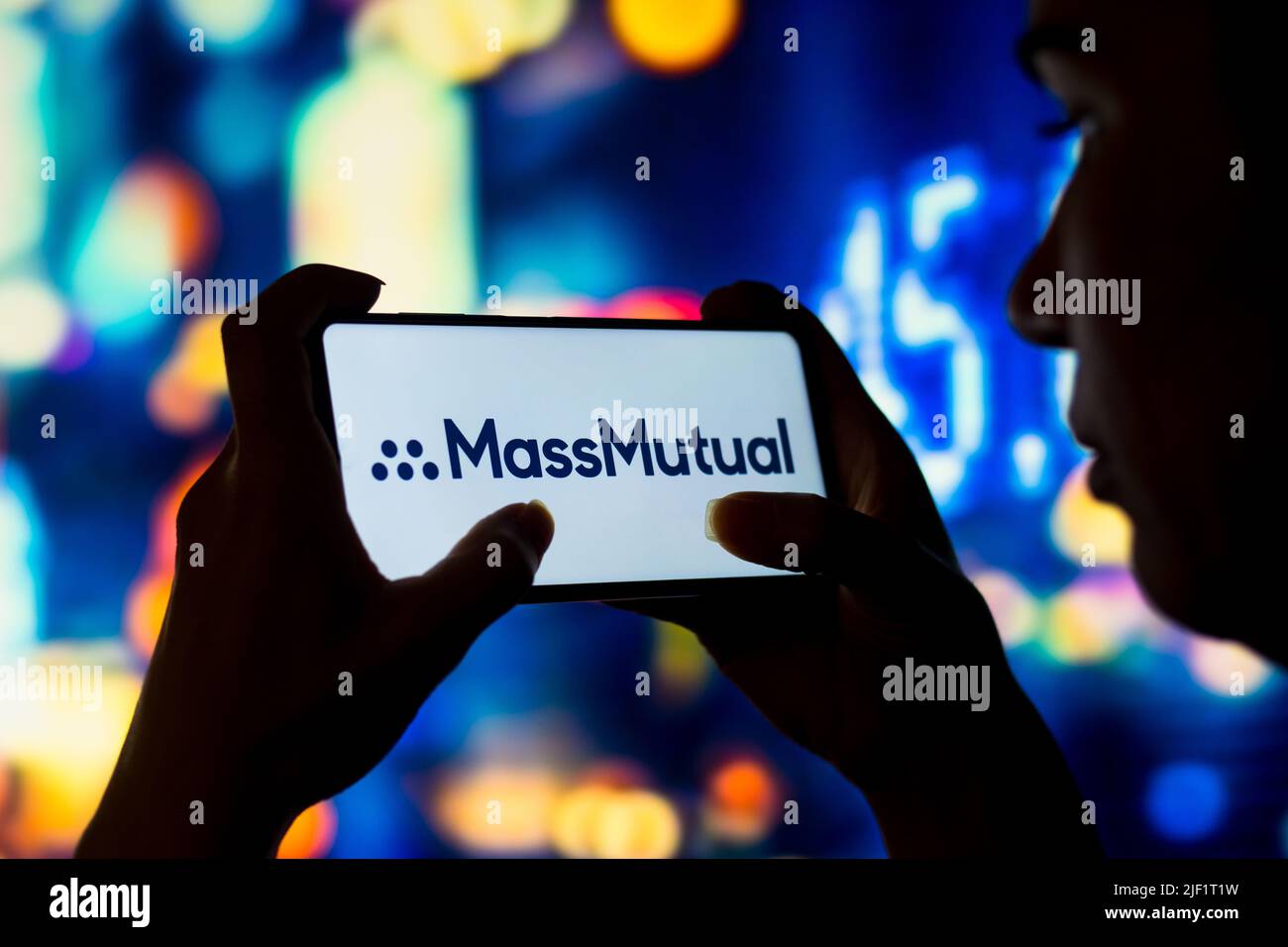 In this photo illustration, a silhouetted woman holds a smartphone with ...