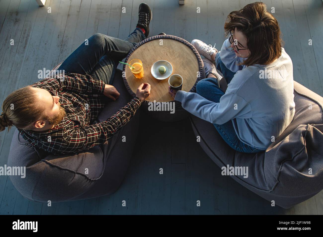 Sitting on bean bags hi-res stock photography and images - Alamy