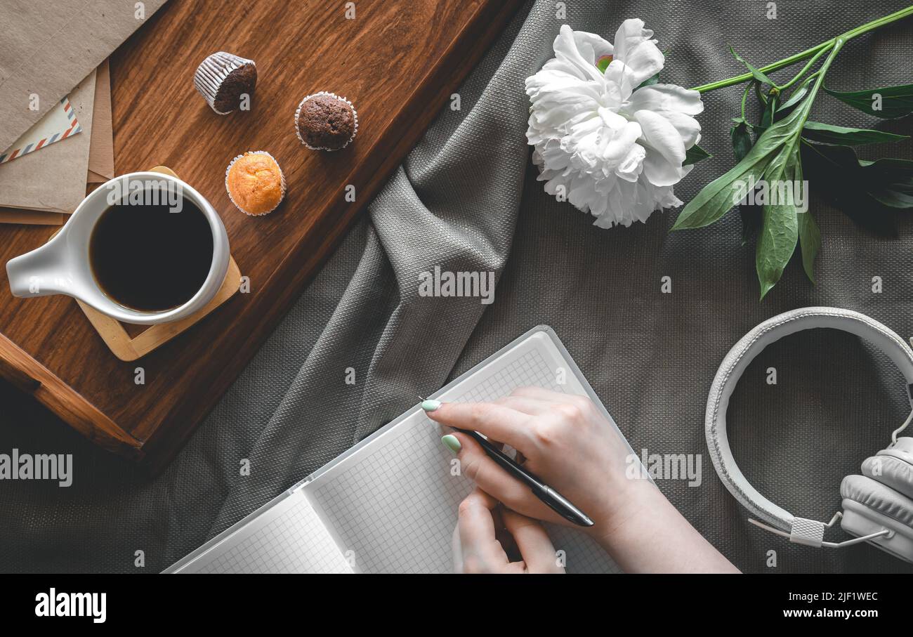 Flat lay composition in bed, with coffee and notepad Stock Photo - Alamy