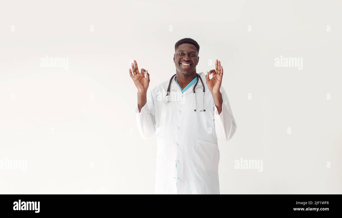 the African-American doctor gestures ok. A man in a white coat says ...