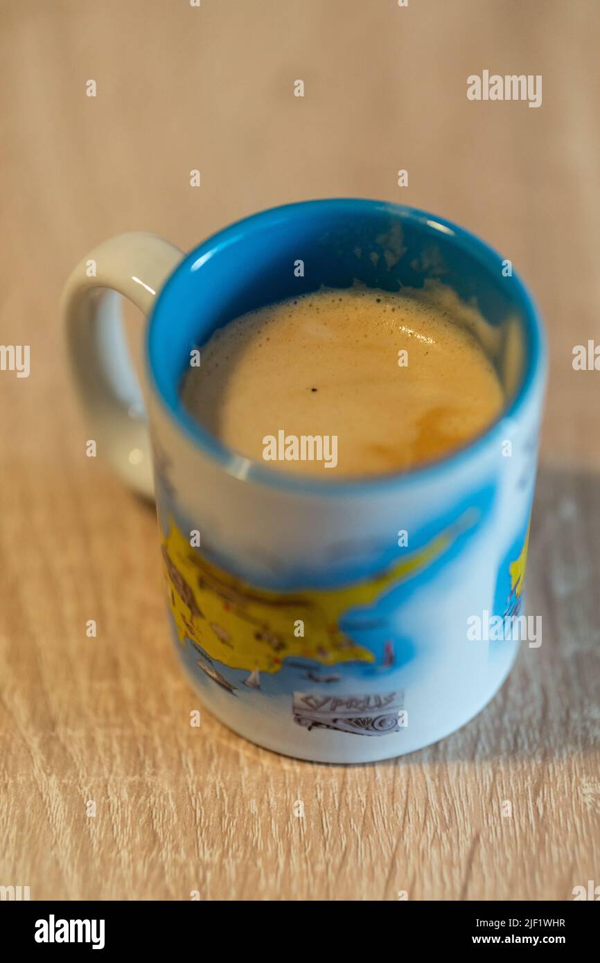 A vertical shot of a Cyprus coffee mug on a wooden table Stock Photo ...
