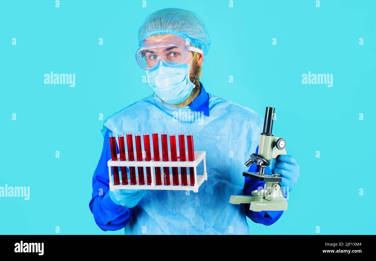 Laboratory work. Doctor in protective suit, glasses and medical mask ...