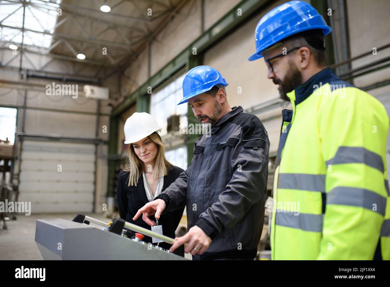 Manager supervisors and industrial worker in uniform doing control in ...