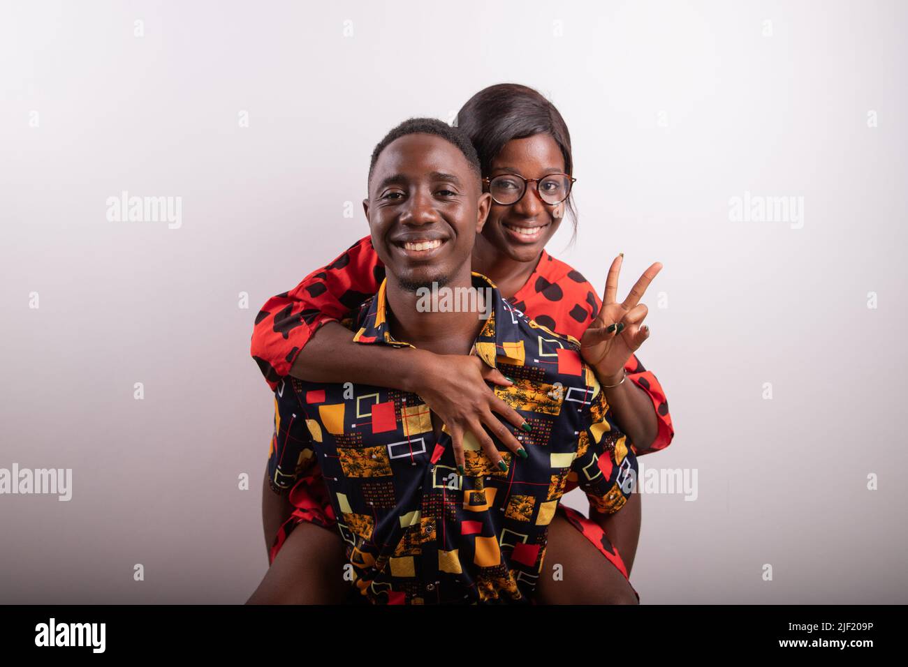 Girlfriend on the back of their boyfriend pose for a photo in the ...