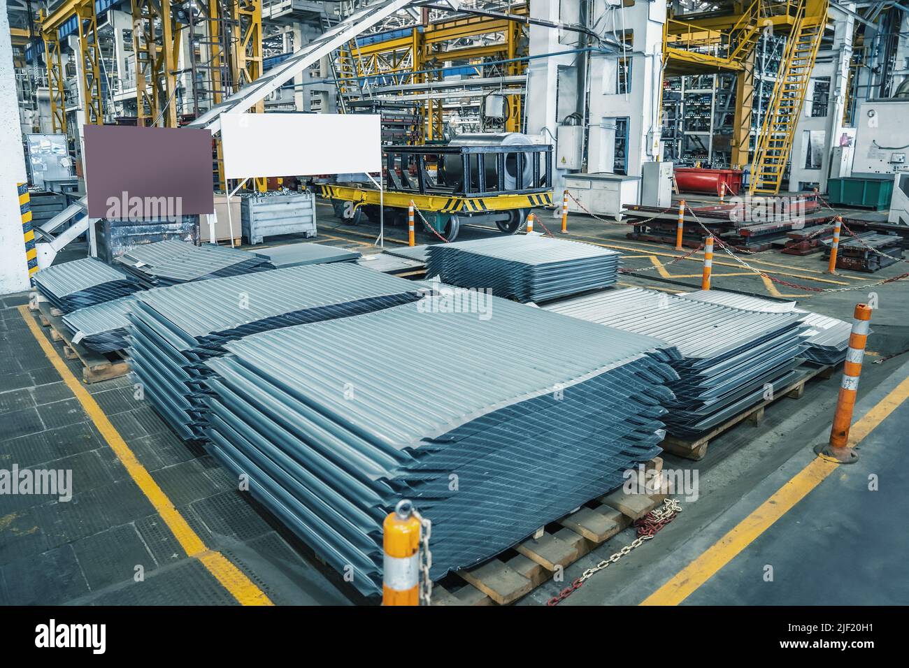 Stacks of metal sheets in metalwork factory warehouse after forming ...