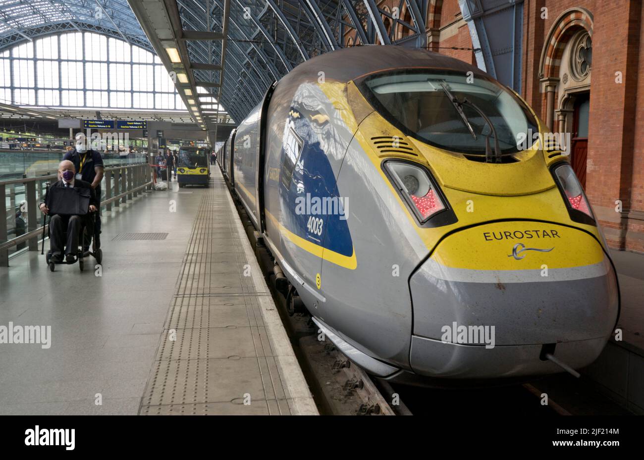 Passenger assisted by wheelchair arriving by Eurostar train to London ...