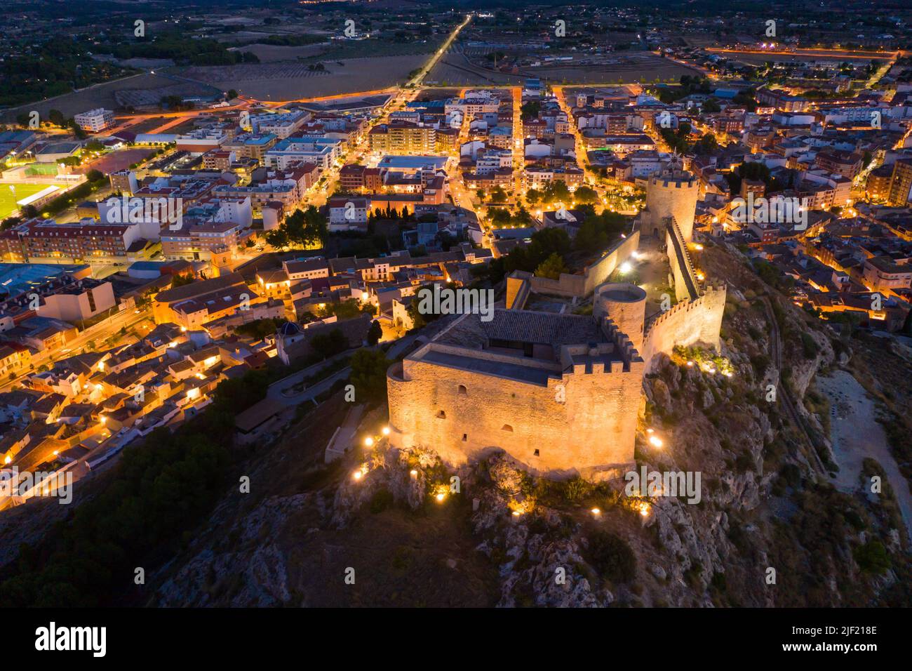 Night view of illuminated hilltop walled castle in Castalla, Spain ...