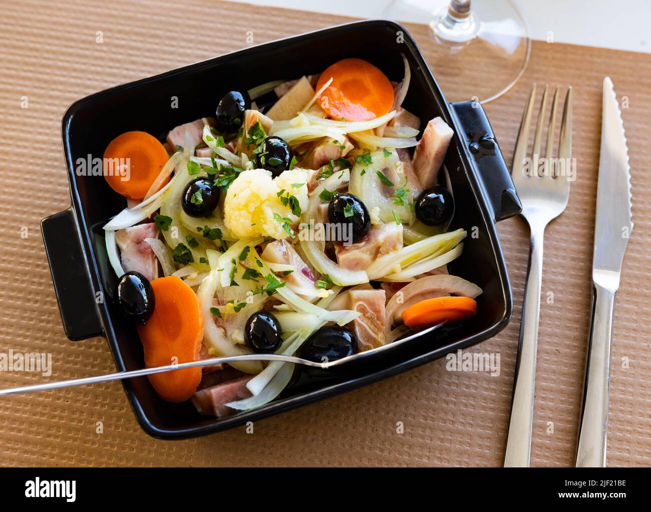 Portuguese traditional salad of pig ears with olives Stock Photo - Alamy