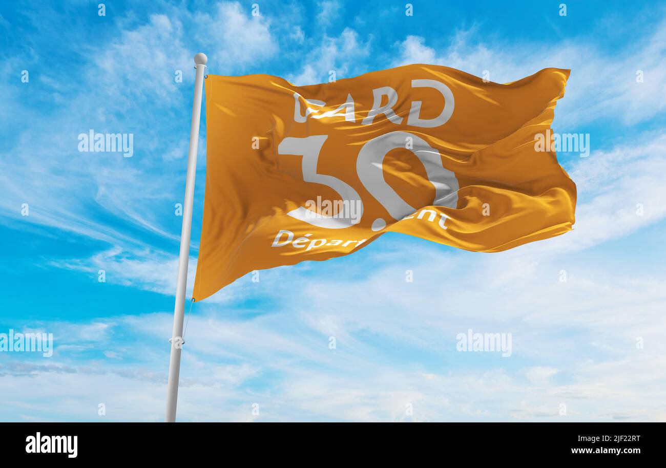 flag of department of Gard, France at cloudy sky background on sunset ...