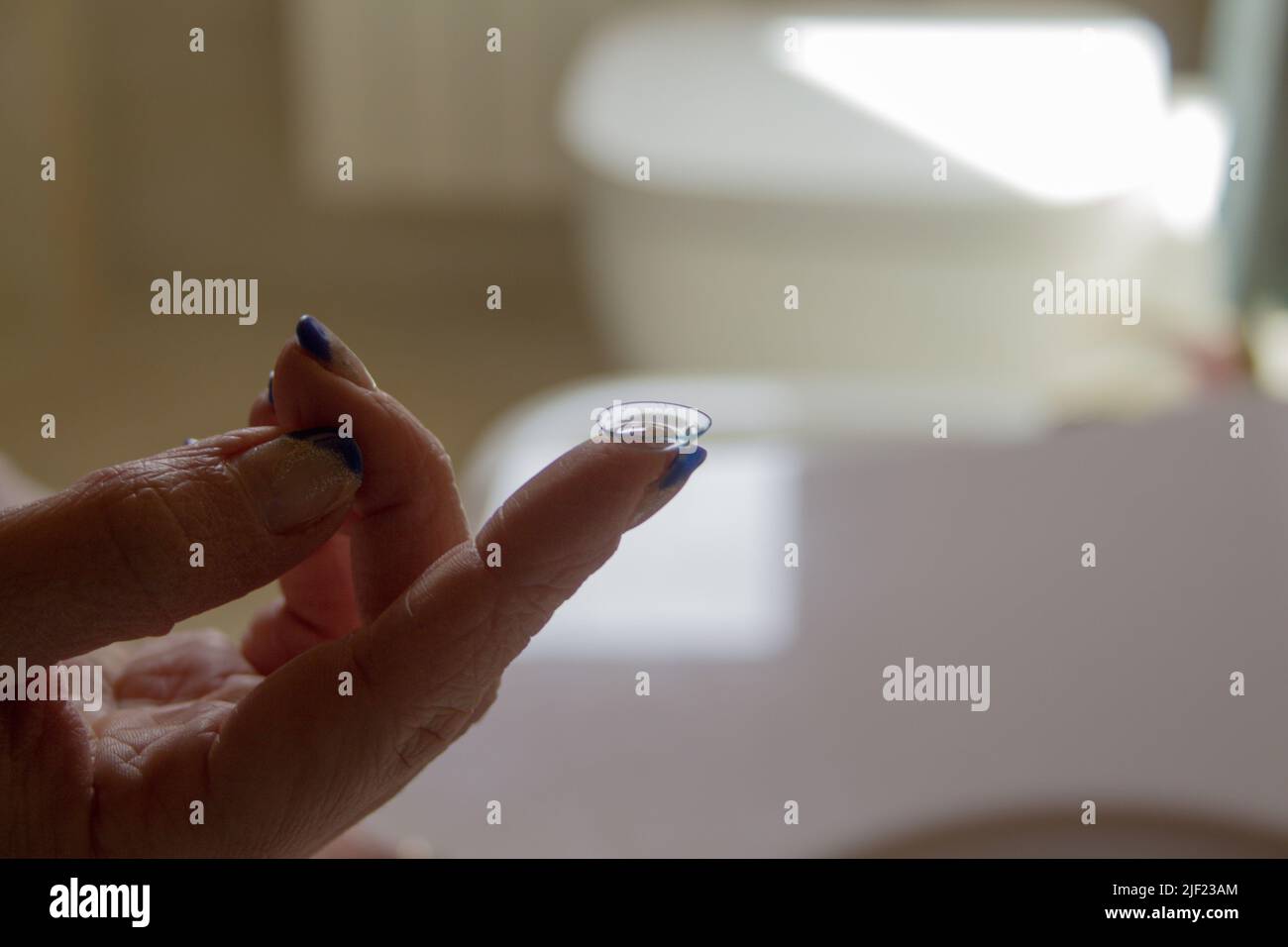 Image of a woman's hand holding a contact lens on her finger Stock ...