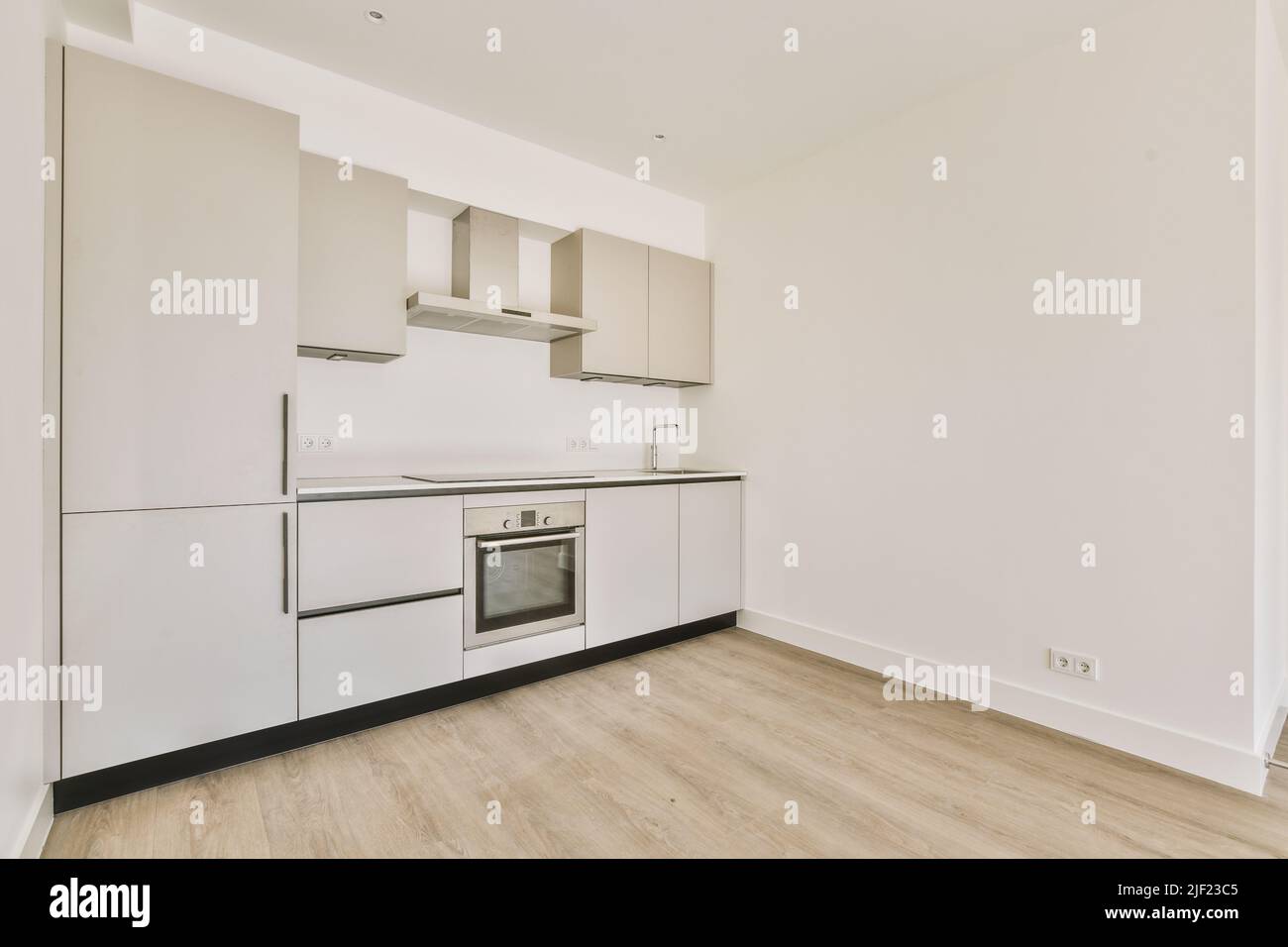 Interior of empty white kitchen with stove and cooker hood and with ...