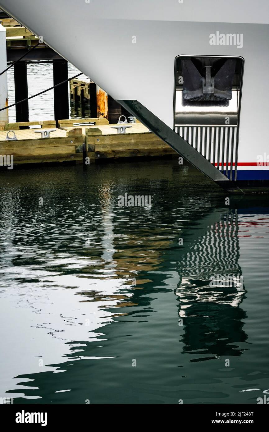 The anchor on the bow of a luxury yacht floating and reflecting on ...