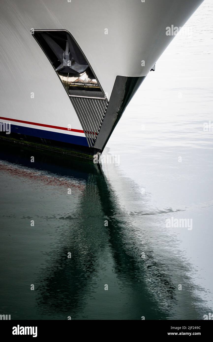 The anchor on the bow of a luxury yacht floating and reflecting on ...