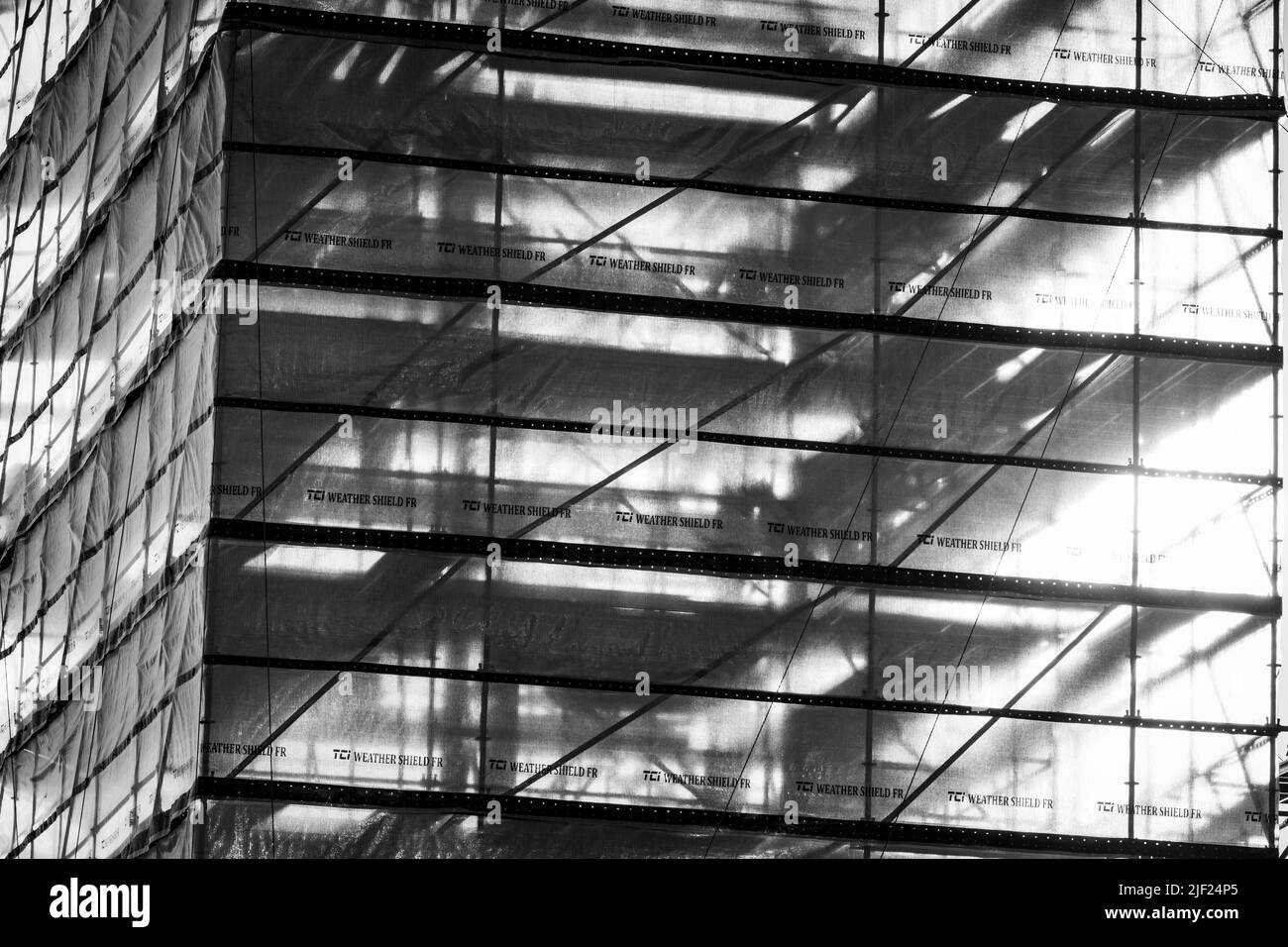 Temporary scaffolding skinned with tarpaulins surrounds the ...