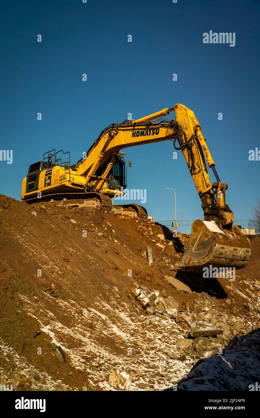 Excavator machinery digging on the Cogswell District project site in ...