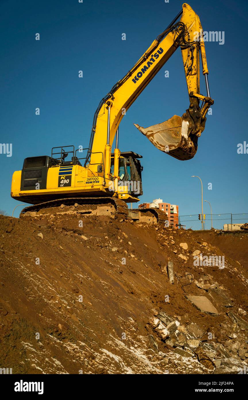 Excavator machinery digging on the Cogswell District project site in ...