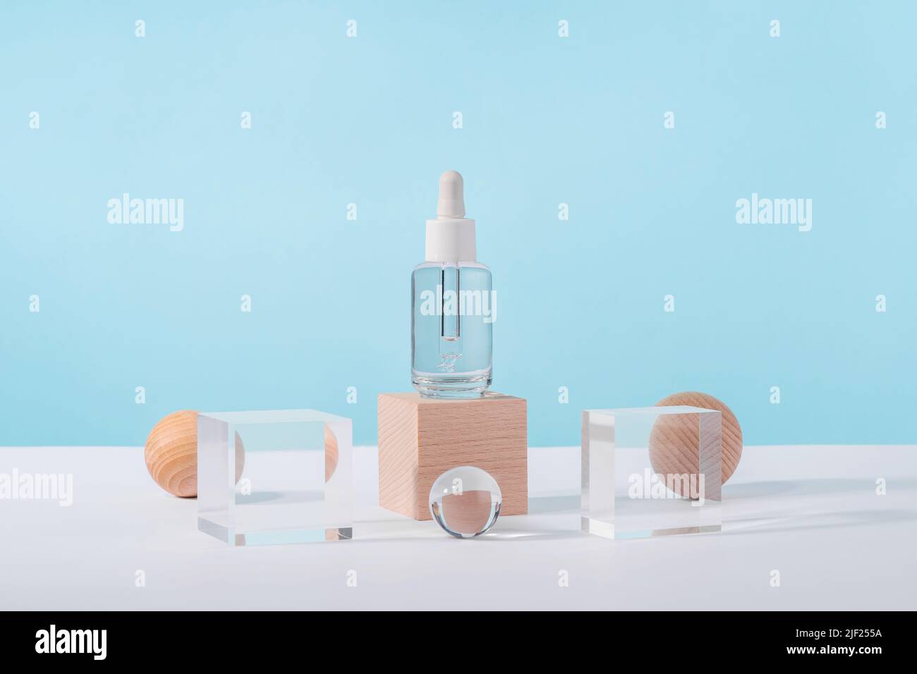 Serum cosmetic bottle with peptides and retinol on acrylic and wooden ...