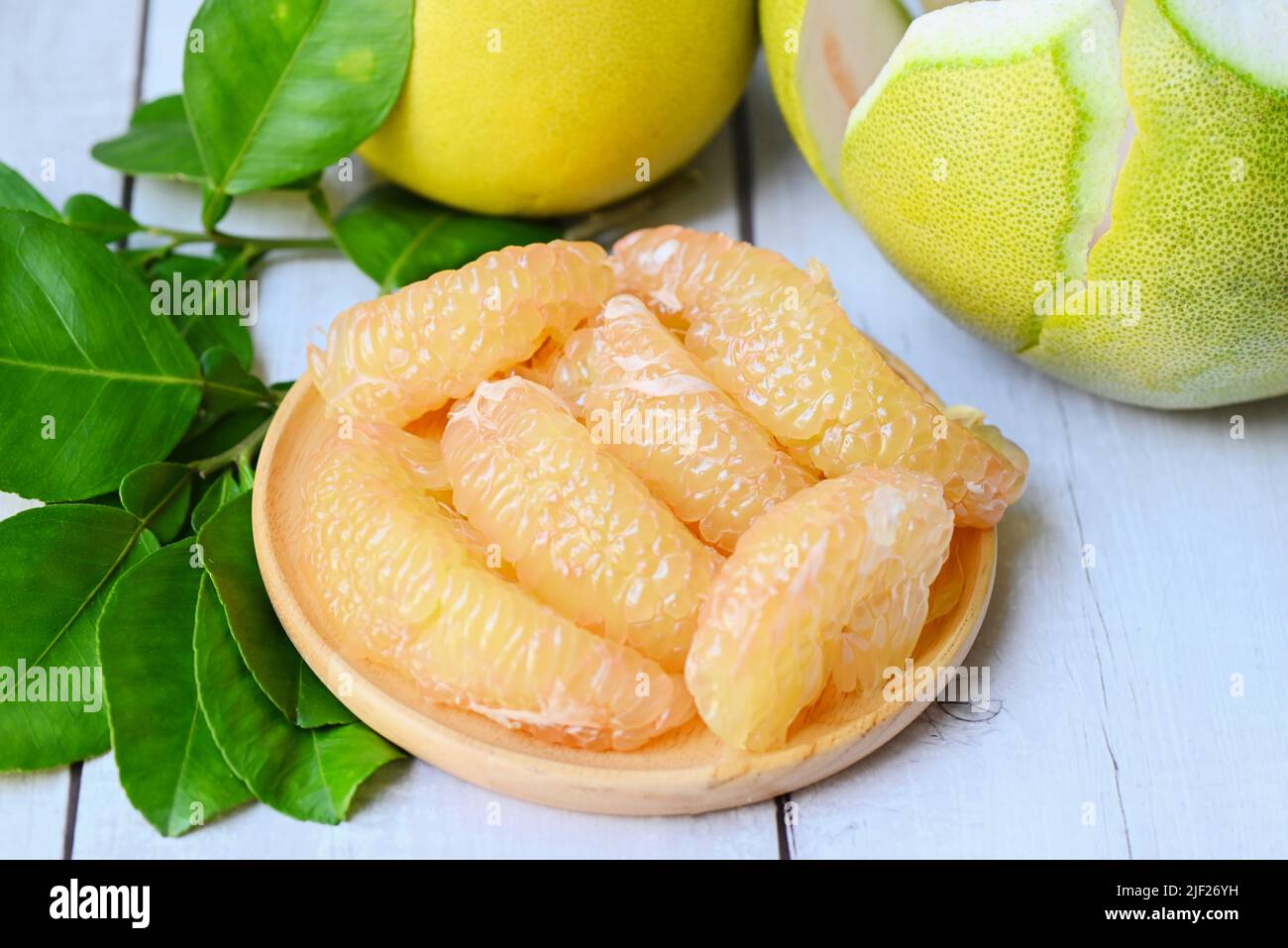 pomelo fruit on wooden plate background, fresh green pomelo peeled and ...