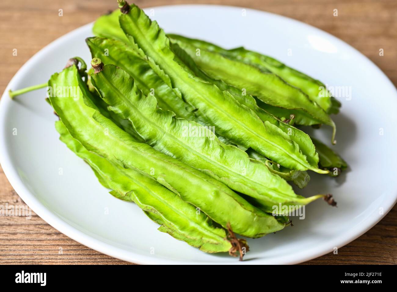 Winged Bean on white plate background, Psophocarpus tetragonolobus ...