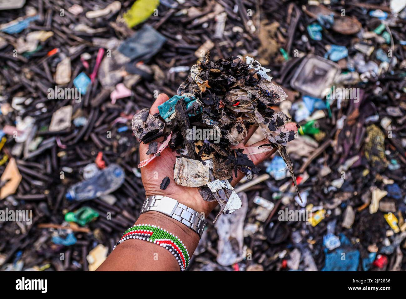 Mombasa, Kenya. 26th June, 2022. A man's hand is seen holding pieces of ...