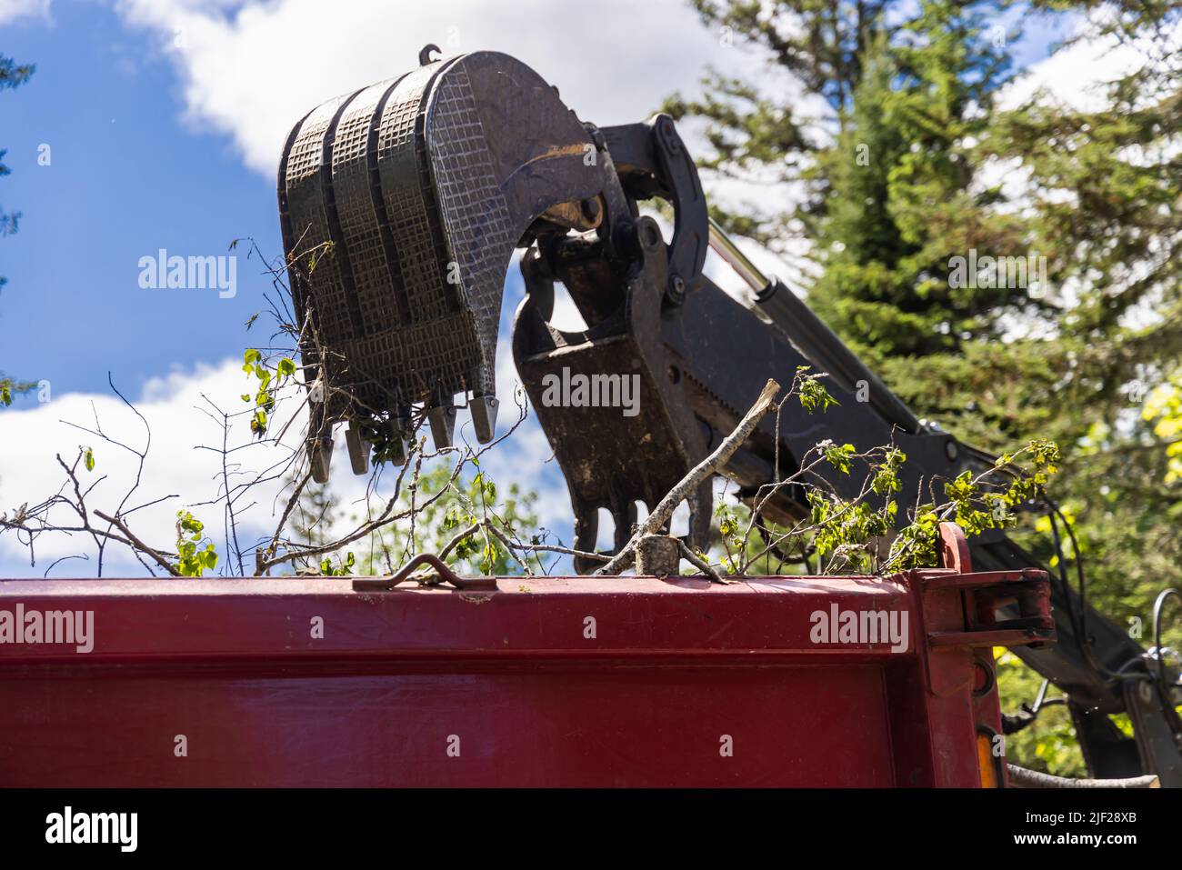 Close up view of the hydraulic arm and scoop bucket of a heavy ...