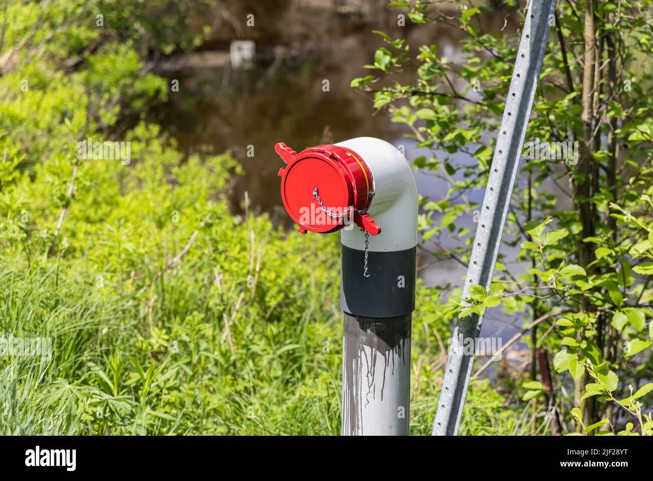 Close up selective focus view of a dry fire hydrant with blurry river ...