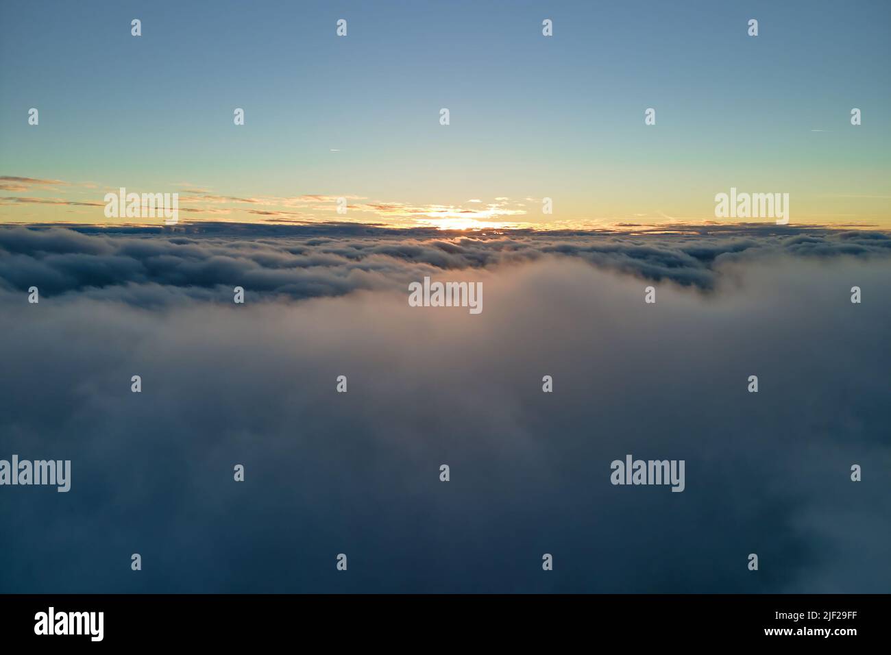 Aerial view from above at high altitude of dense puffy cumulus clouds ...
