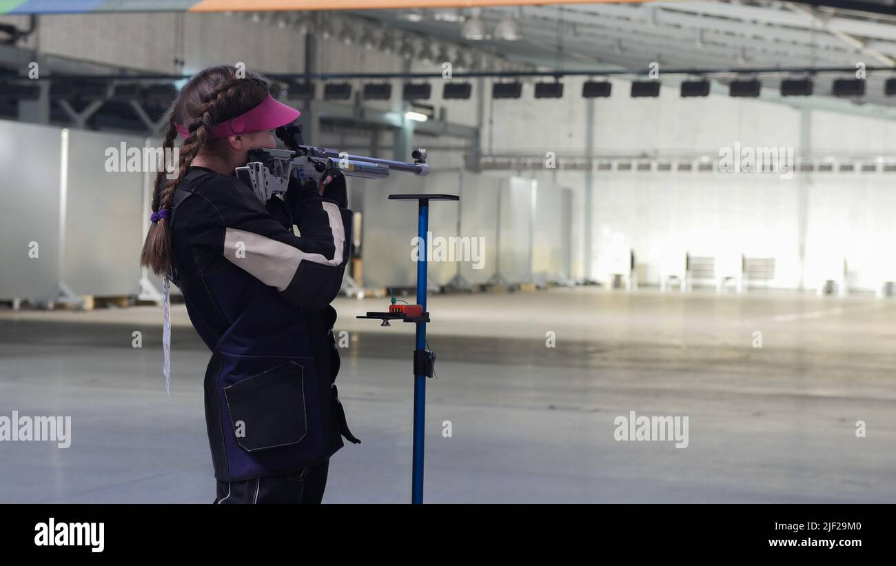 BULLET SHOOTING. girl with pigtails is shooting Stock Photo - Alamy
