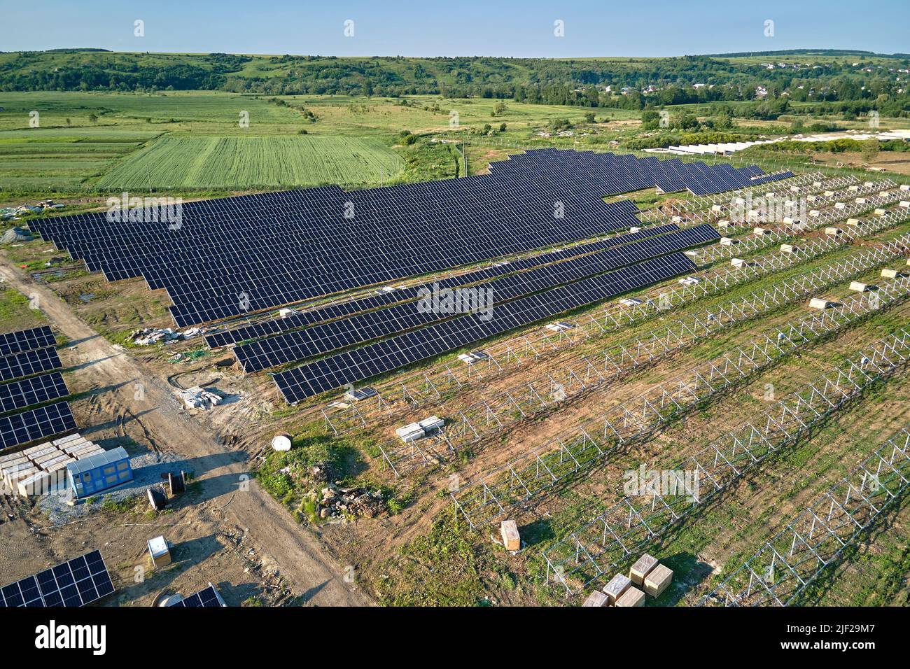 Aerial view of big electric power plant under construction with many ...