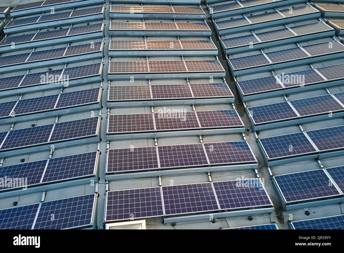 Aerial view of blue photovoltaic solar panels mounted on industrial ...