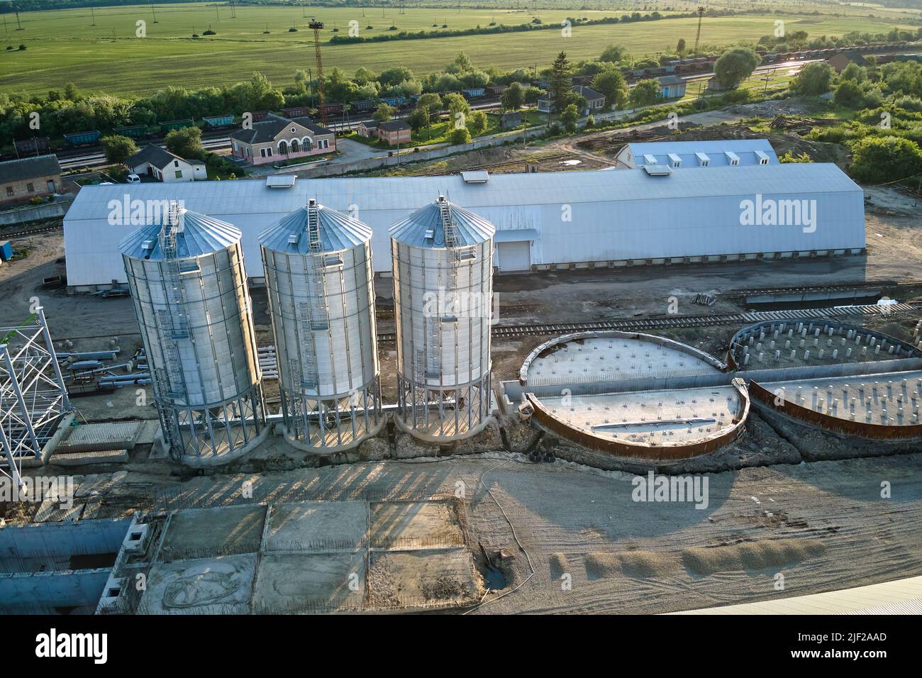 Aerial view of industrial ventilated silos for long term storage of grain and oilseed. Metal ...