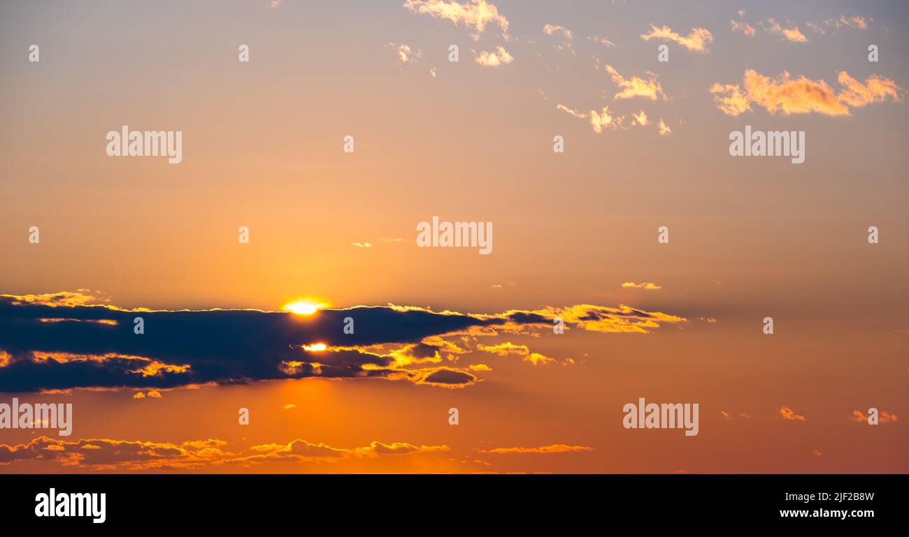 Bright colorful sunset sky with rays of setting sun and vivid dark ...