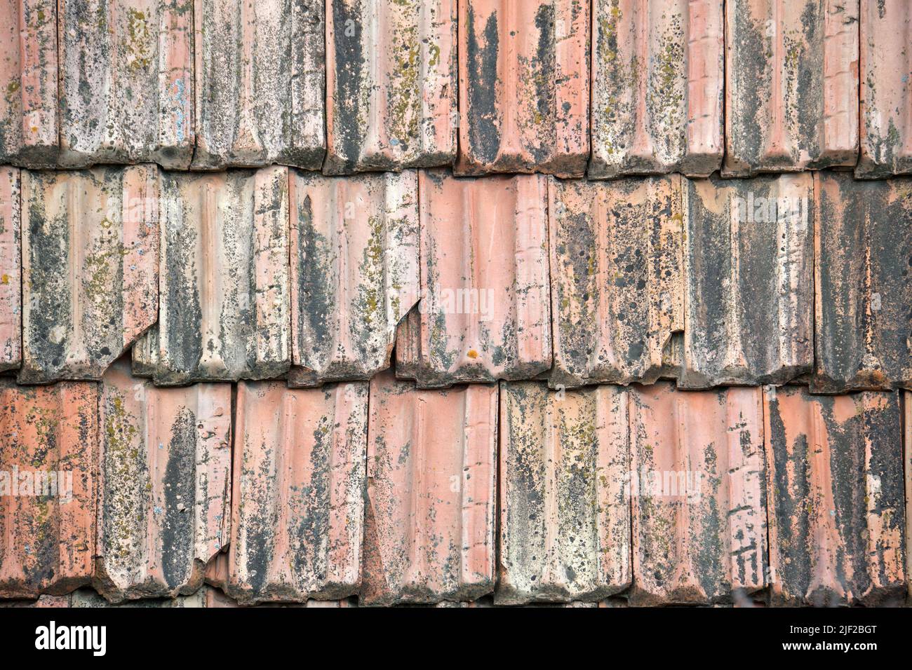 Closeup surface of old weathered ceramic tiles covering building roof ...
