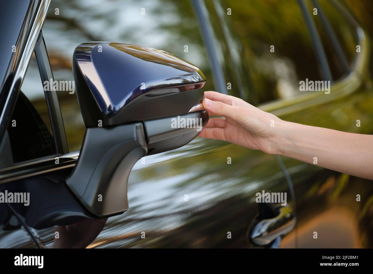 Driver hands adjusting side view mirror of a car Stock Photo - Alamy