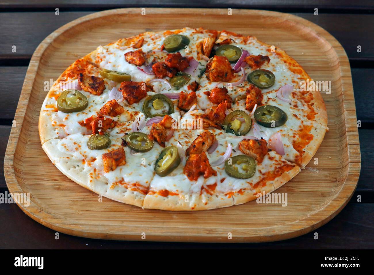 italian thin crust pizza with marinated chicken, mozzarella cheese ...