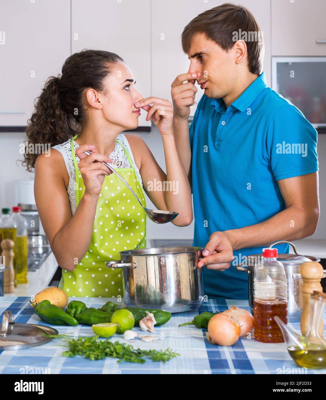 adults feeling foul smell of food from casserole Stock Photo - Alamy